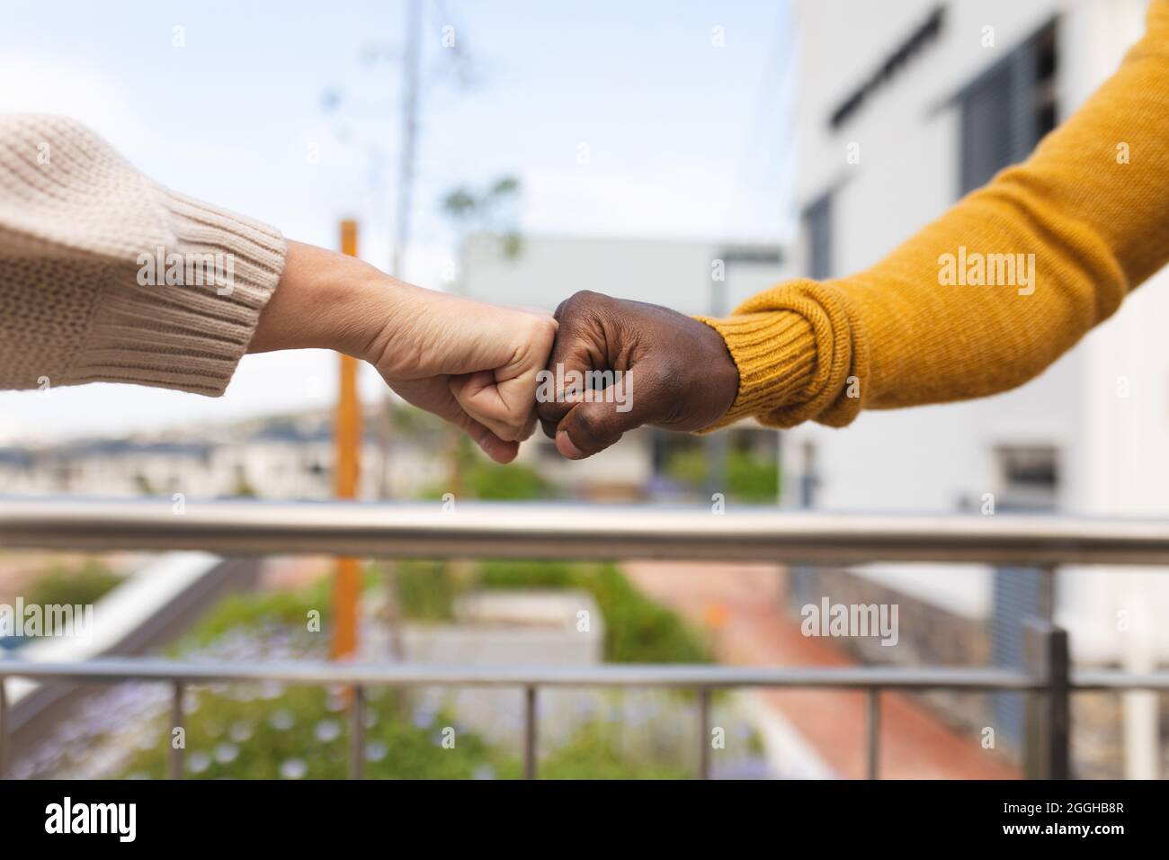 Diverse male and female colleagues at work, fist bumping Stock Photo ...