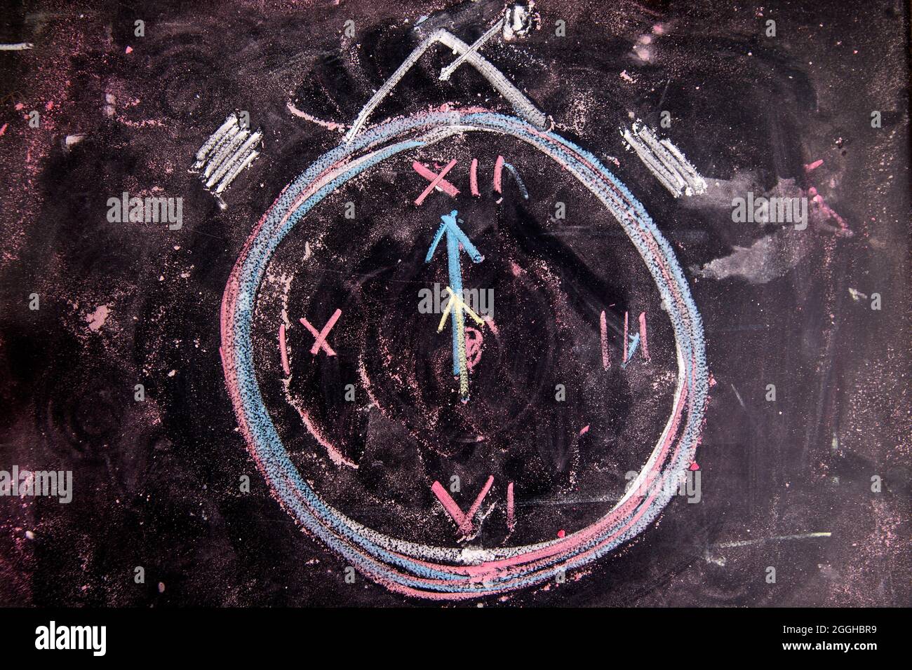 Graphic representation with chalk on the blackboard of a alarm clock ...