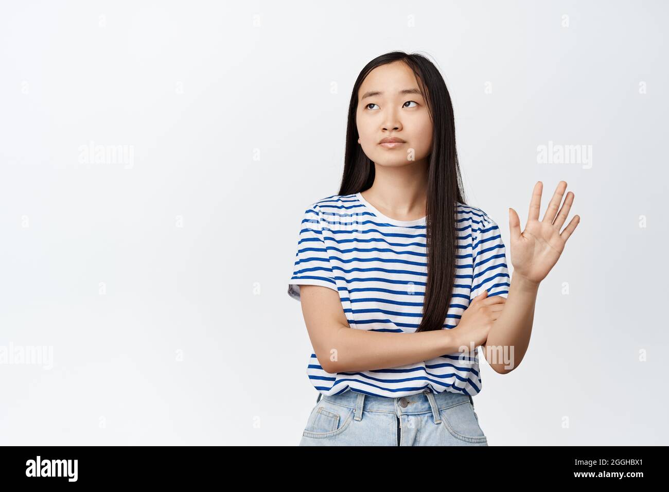 Unamused arrogant asian girl showing a hand gesture, looking away with ...