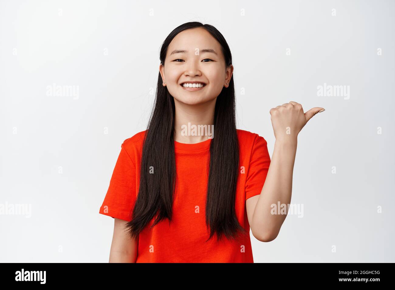 This way. Smiling asian woman demonstrating banner, showing way ...
