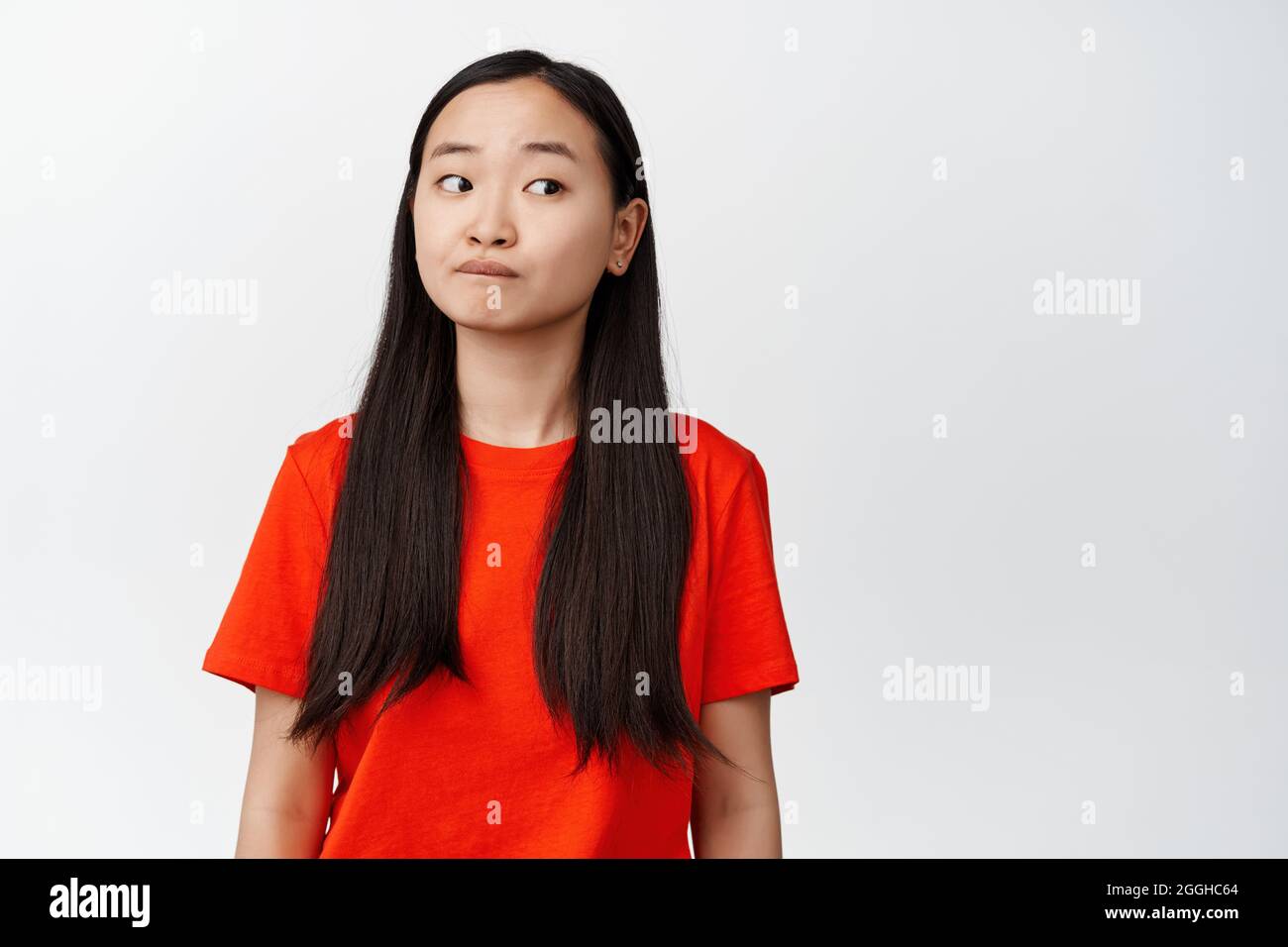 Image of thoughtful brunette girl looking intrigued, thinking of ...