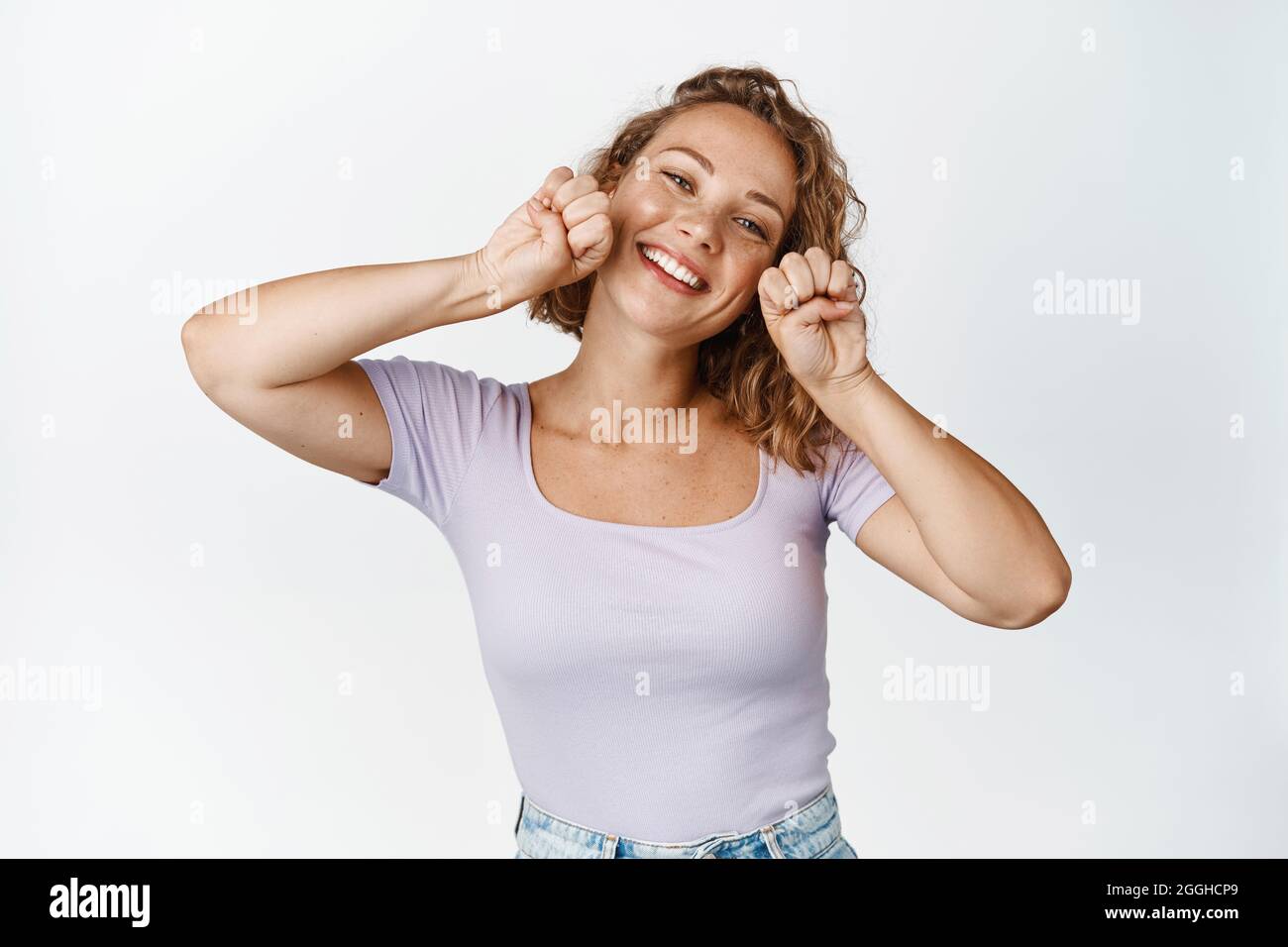 Cute and funny blond girl shows paws gesture, smiles kawaii, stands ...