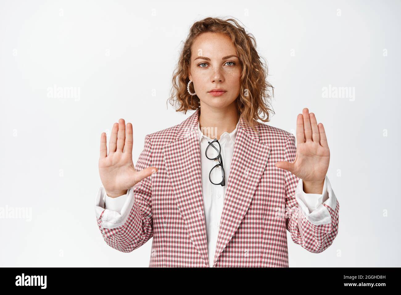 Serious business woman raising hands in stop sign, prohibit something ...