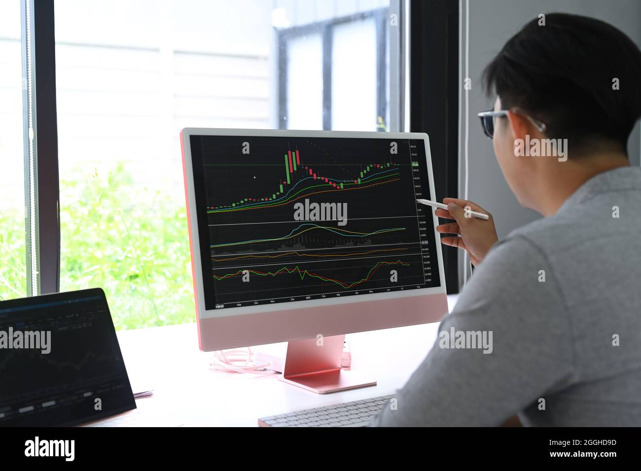 Businessman analyzing investment charts on screen of computer at office ...