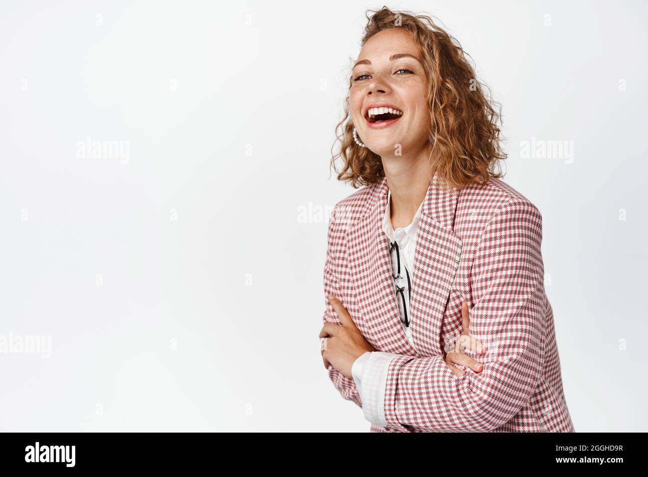 Carefree business woman laughing, cross arms over chest, smiling and ...