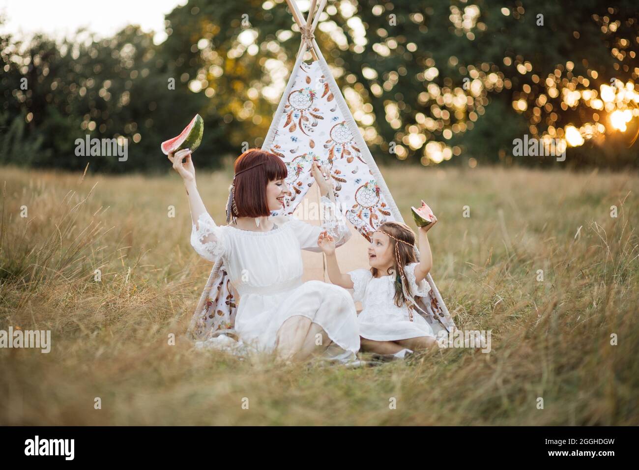 Happy native Anerican family mother and little daughter, relaxing in ...