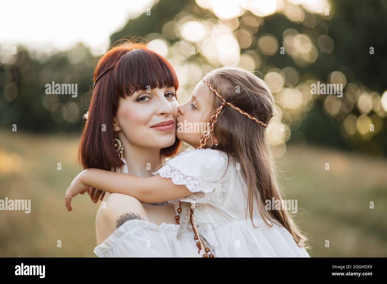 Close up of lovely little 4-years old girl, embracing her pretty caring ...