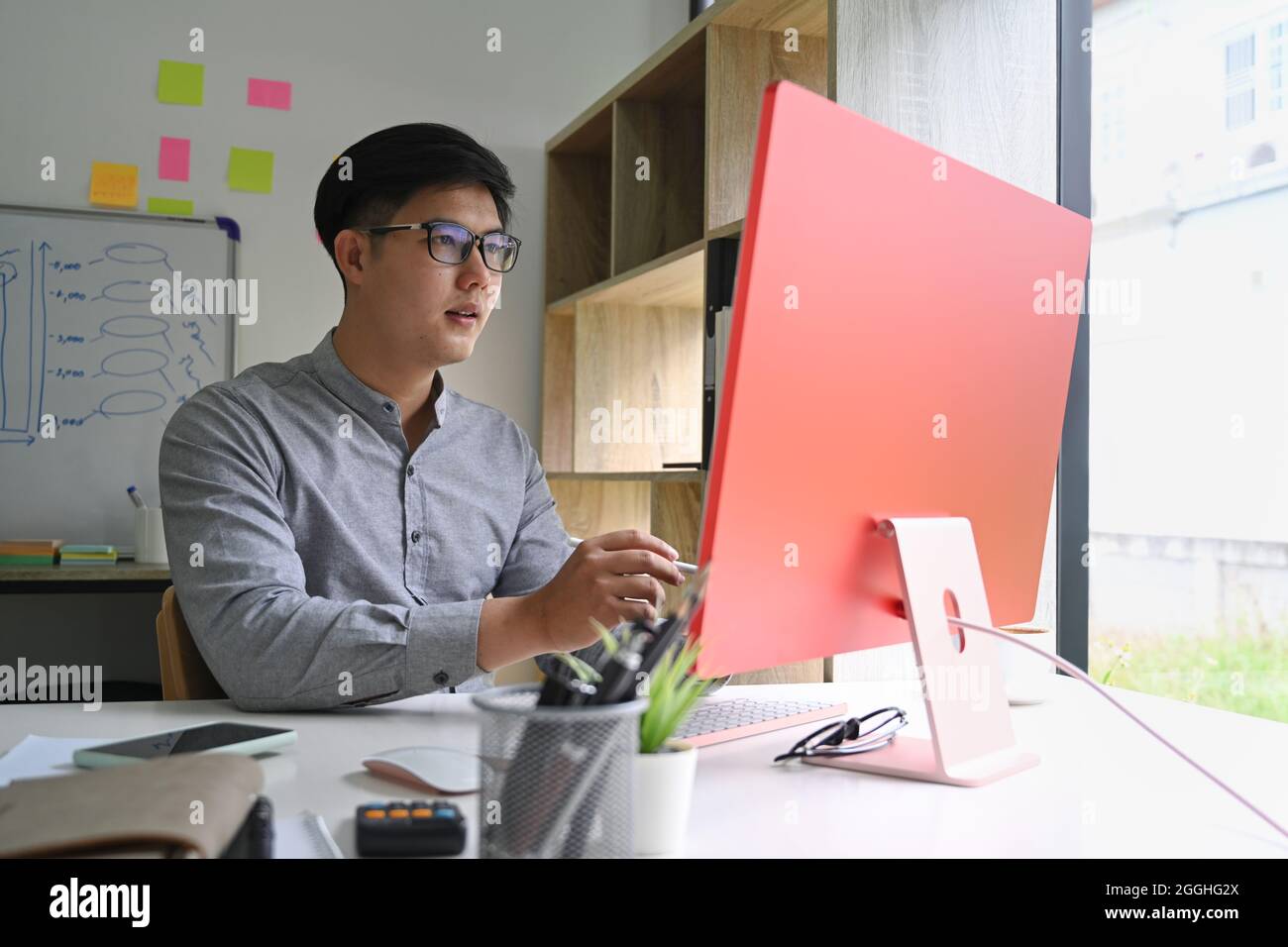Successful businessman working with computer in modern office room ...