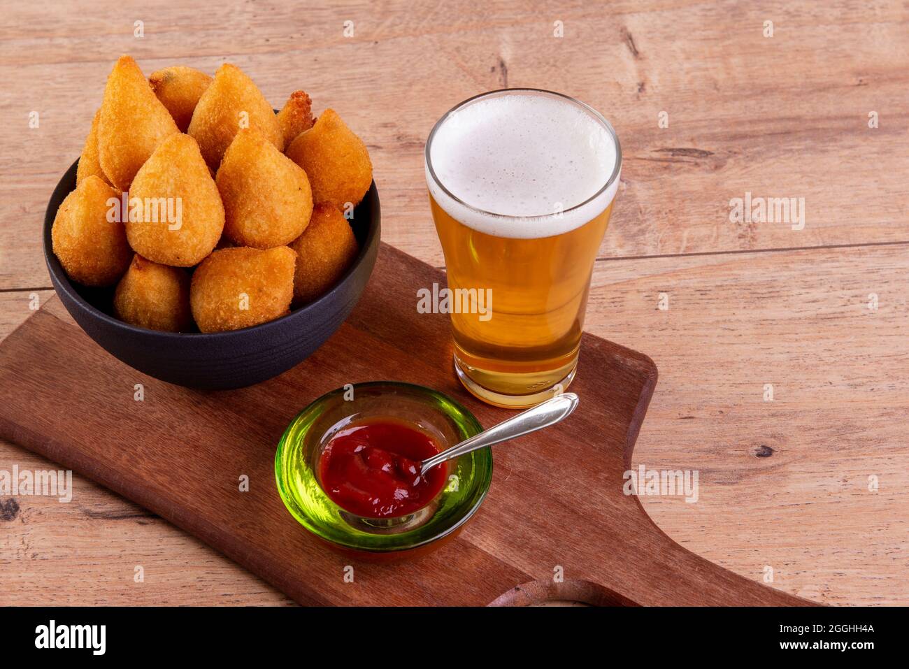 traditional Brazilian fried snack made with chicken known as "coxinha ...