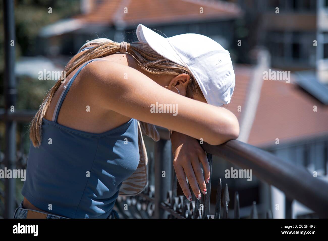 A teenage girl stands on the observation deck above the city with her ...
