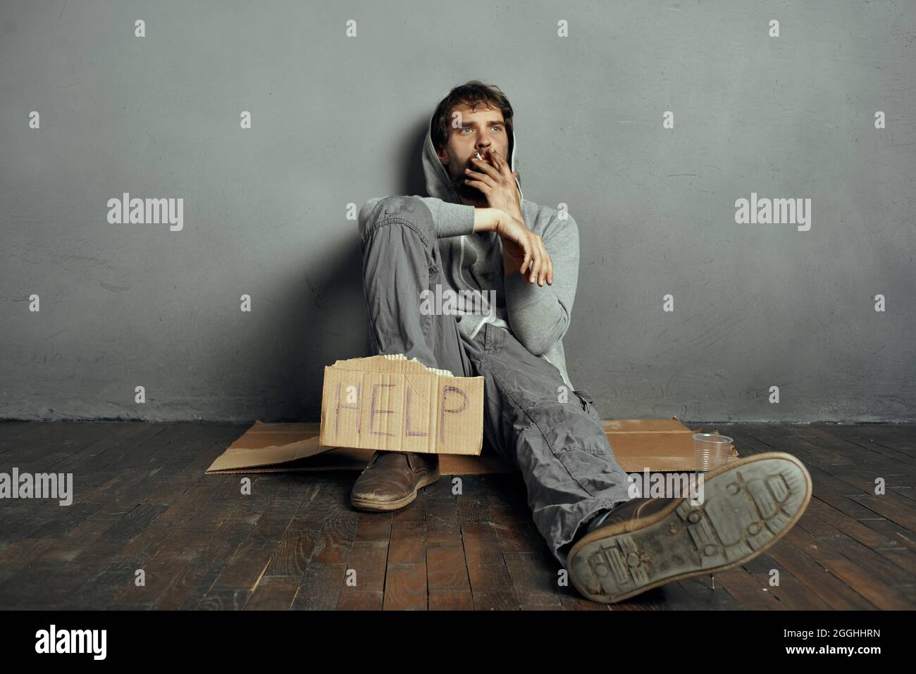 bearded bum sits on the floor holding a sign Help depression lifestyle ...