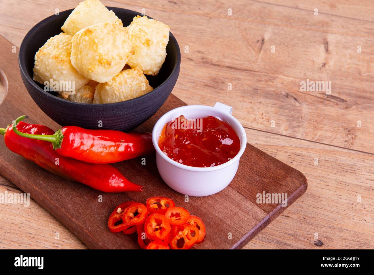 Tapioca dice served with pepper jelly. Wooden table Stock Photo - Alamy