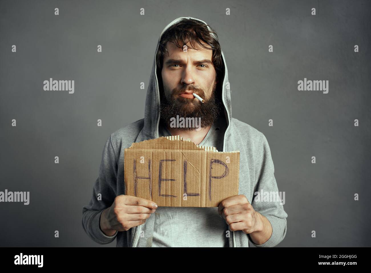 bearded homeless man holding a sign Help emotions poverty on the street ...