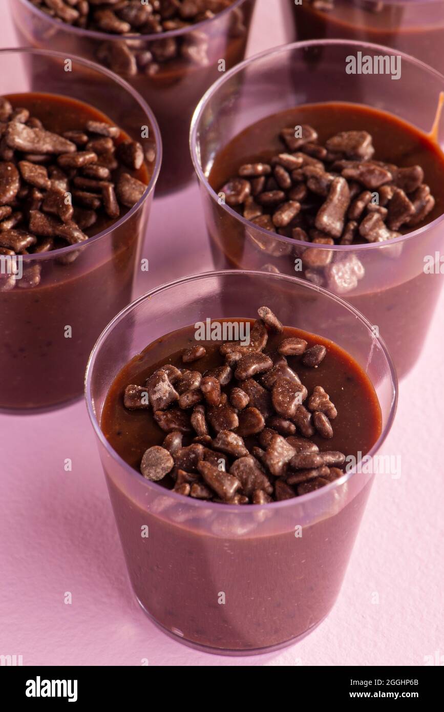 acrylic cups with brigadeiro and chocolate sprinkles on lilac ...