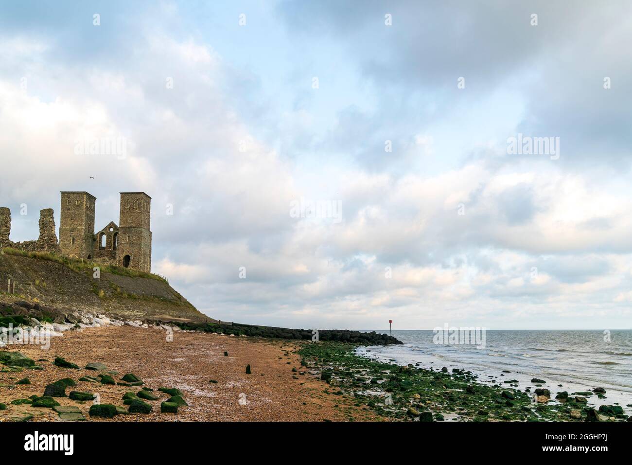 The beach, seawall and 12th century twin towers of the ruins of the ...