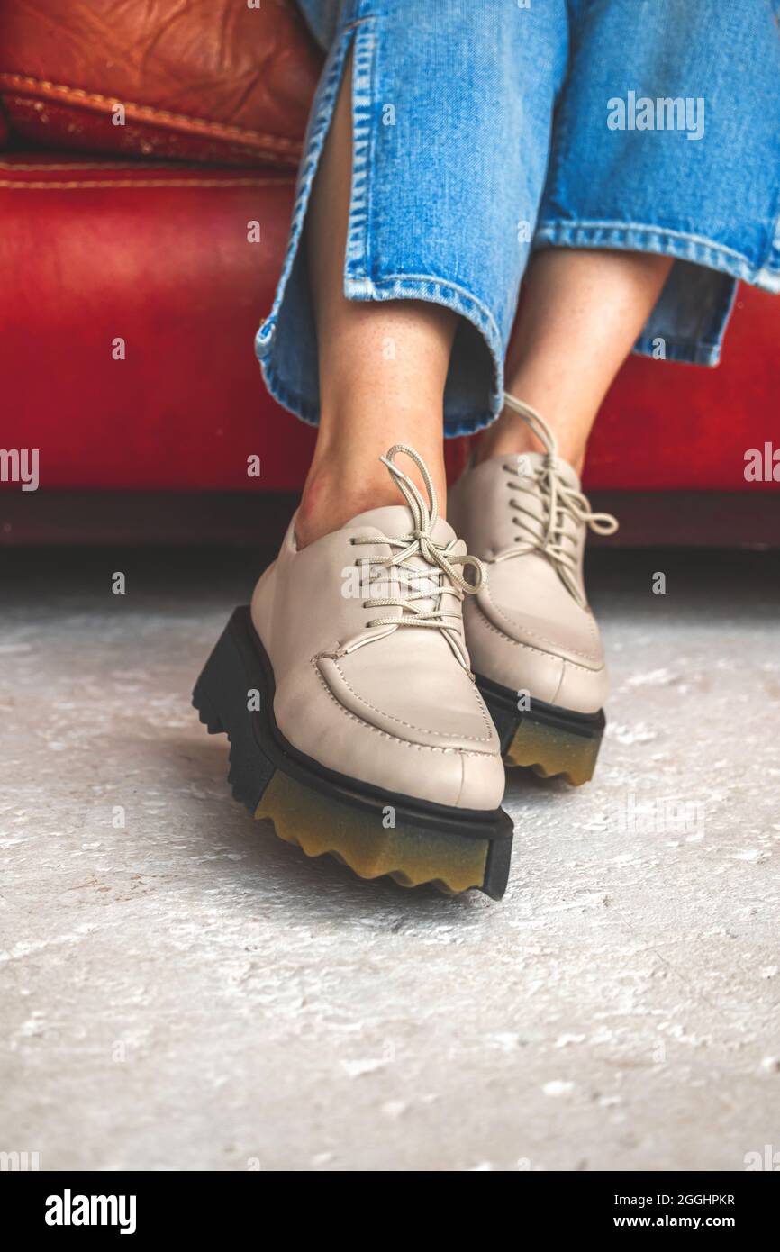 Urban fashion shoes. Casual sneakers on teen girl legs in denim jeans ...