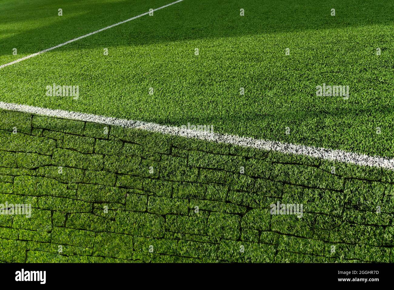green artificial grass football or soccer field with white line and ...