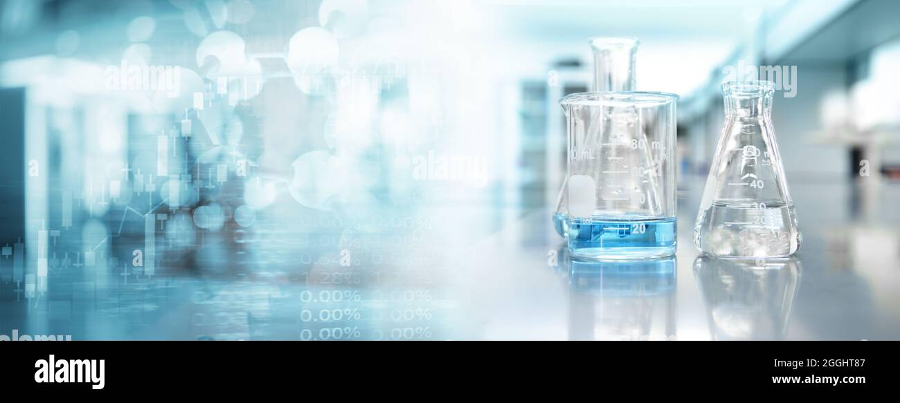 glass beaker and flask with blue solution with soft information and ...