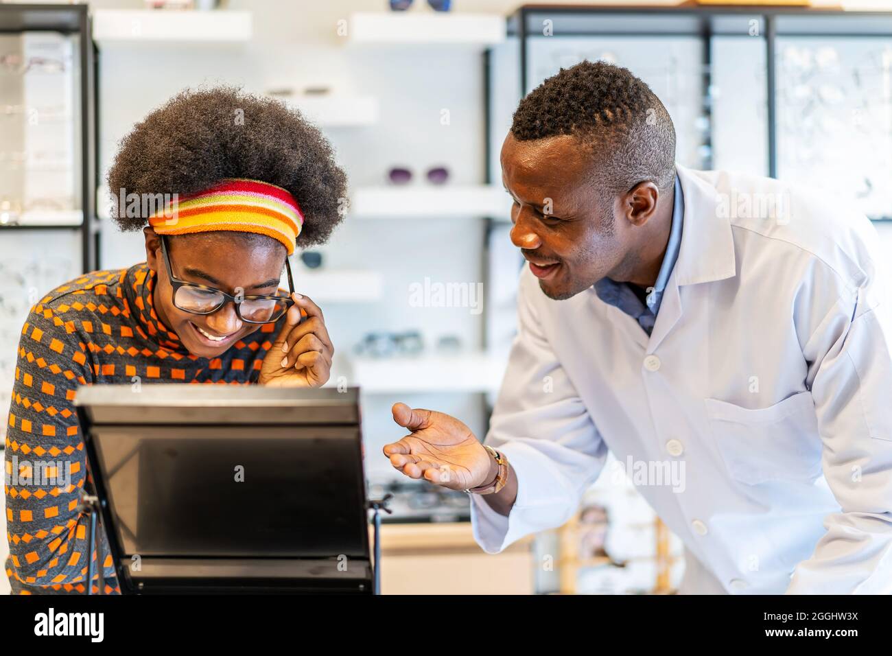 Man professional optician helping and selling young woman choosing ...