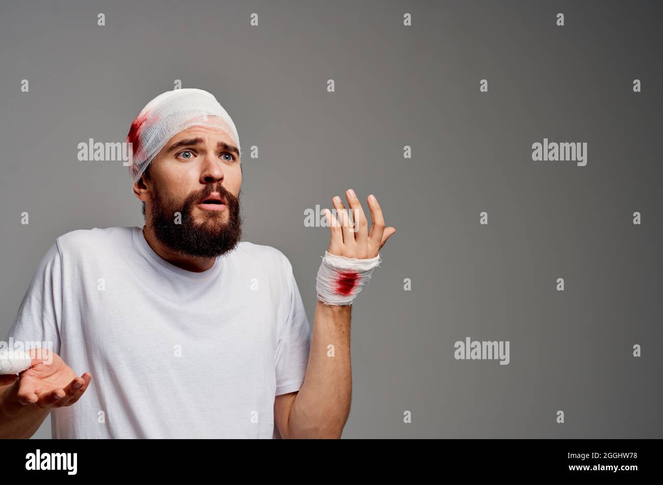 bearded man bandaged head and hand blood isolated background Stock ...