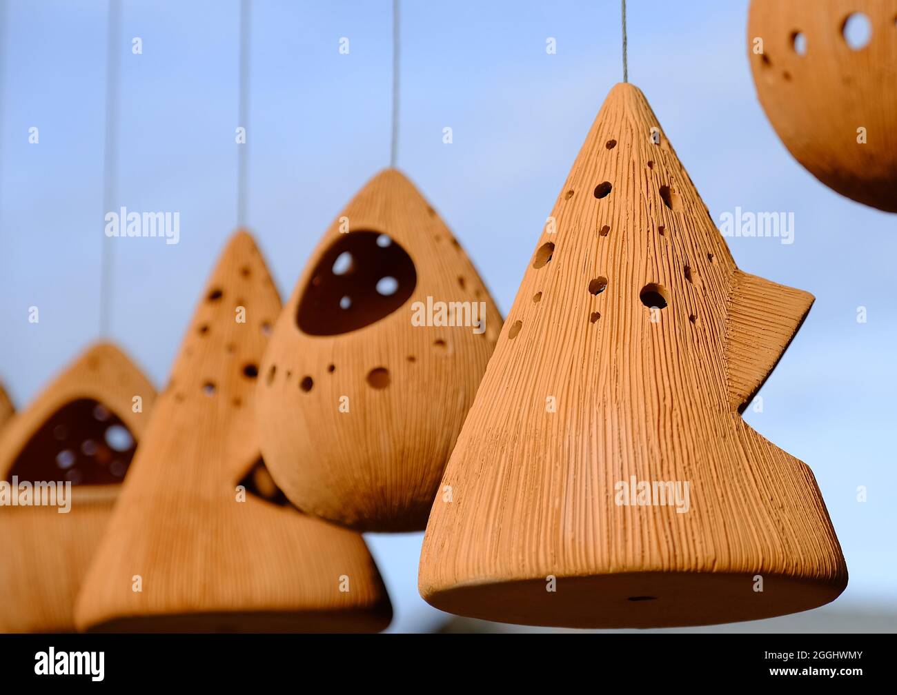 Terracotta bird houses hanging by the string Stock Photo - Alamy
