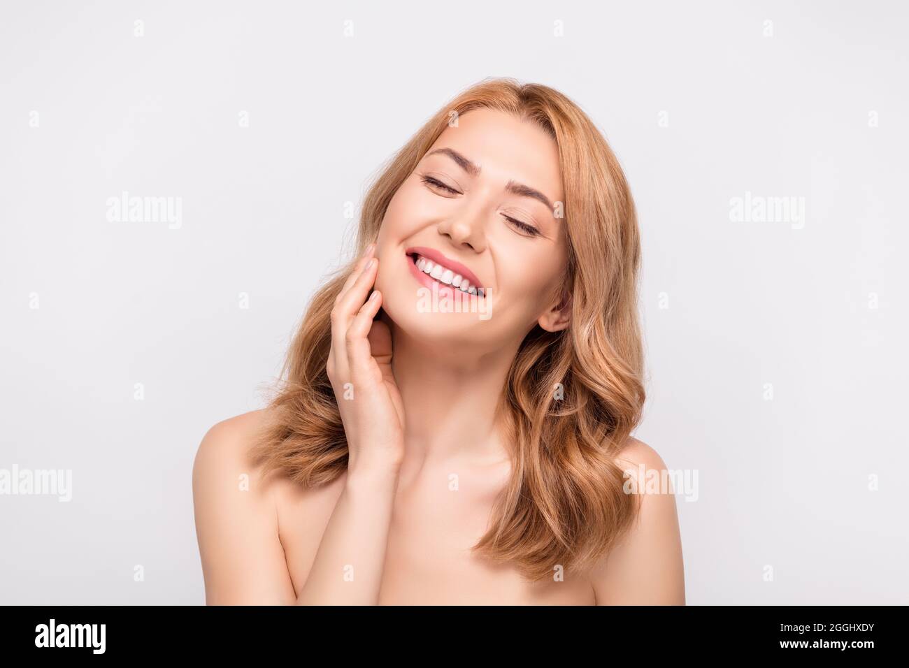 Photo portrait woman touching cheeks smooth skin smiling overjoyed ...