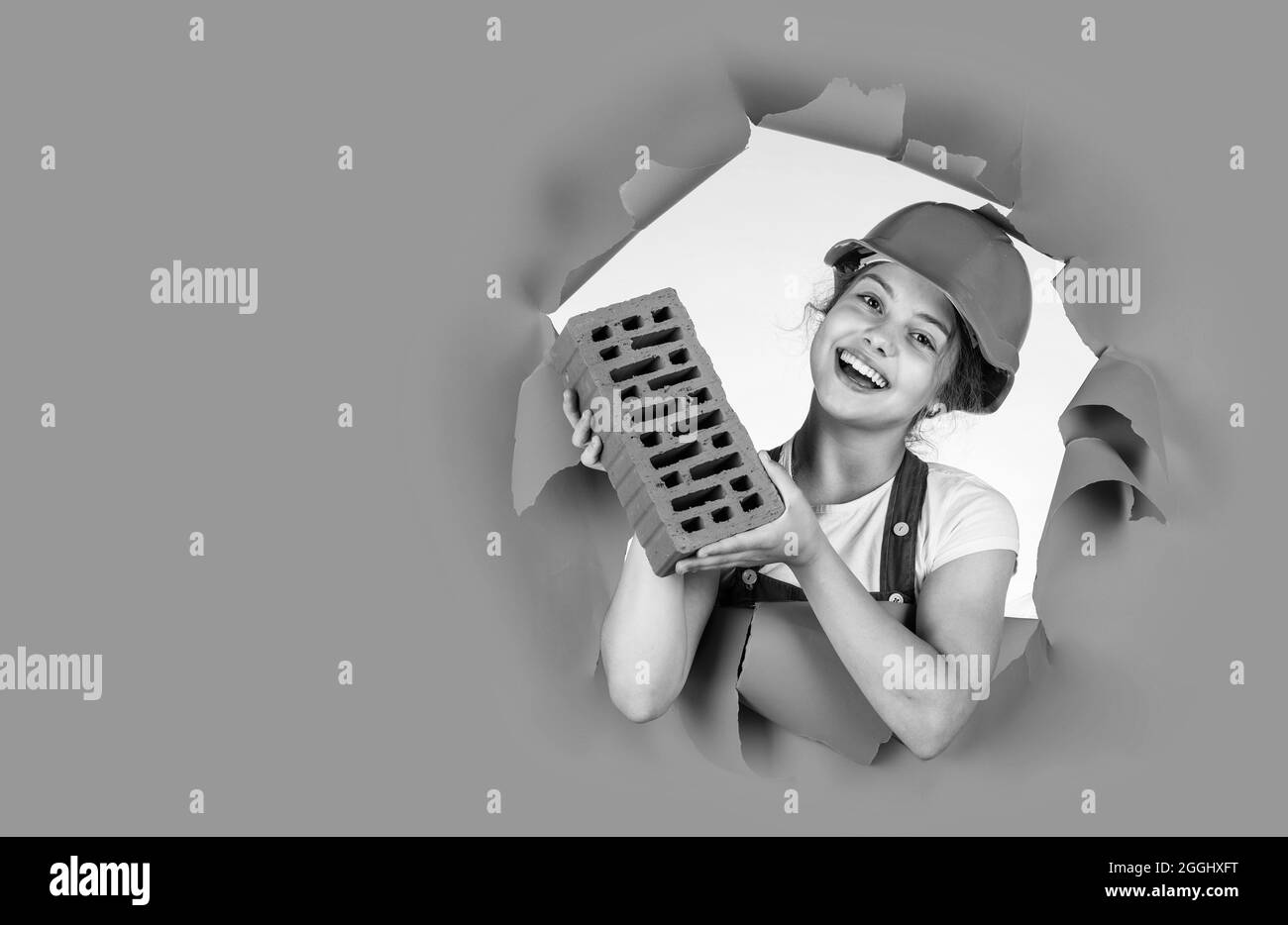 Real professional. kid wear helmet on construction site. teen girl ...