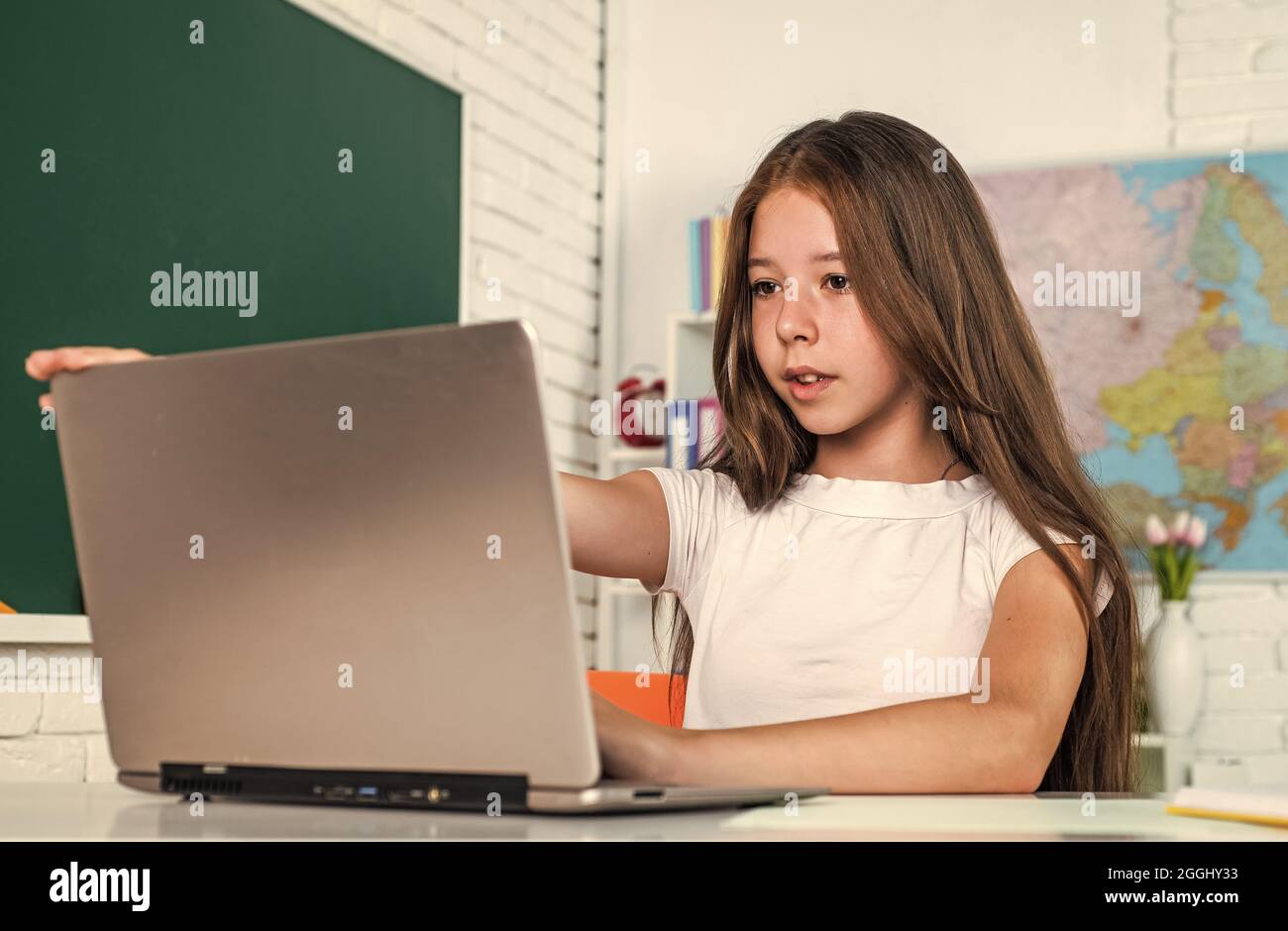 cheerful kid girl with computer at school lesson, e learning Stock ...