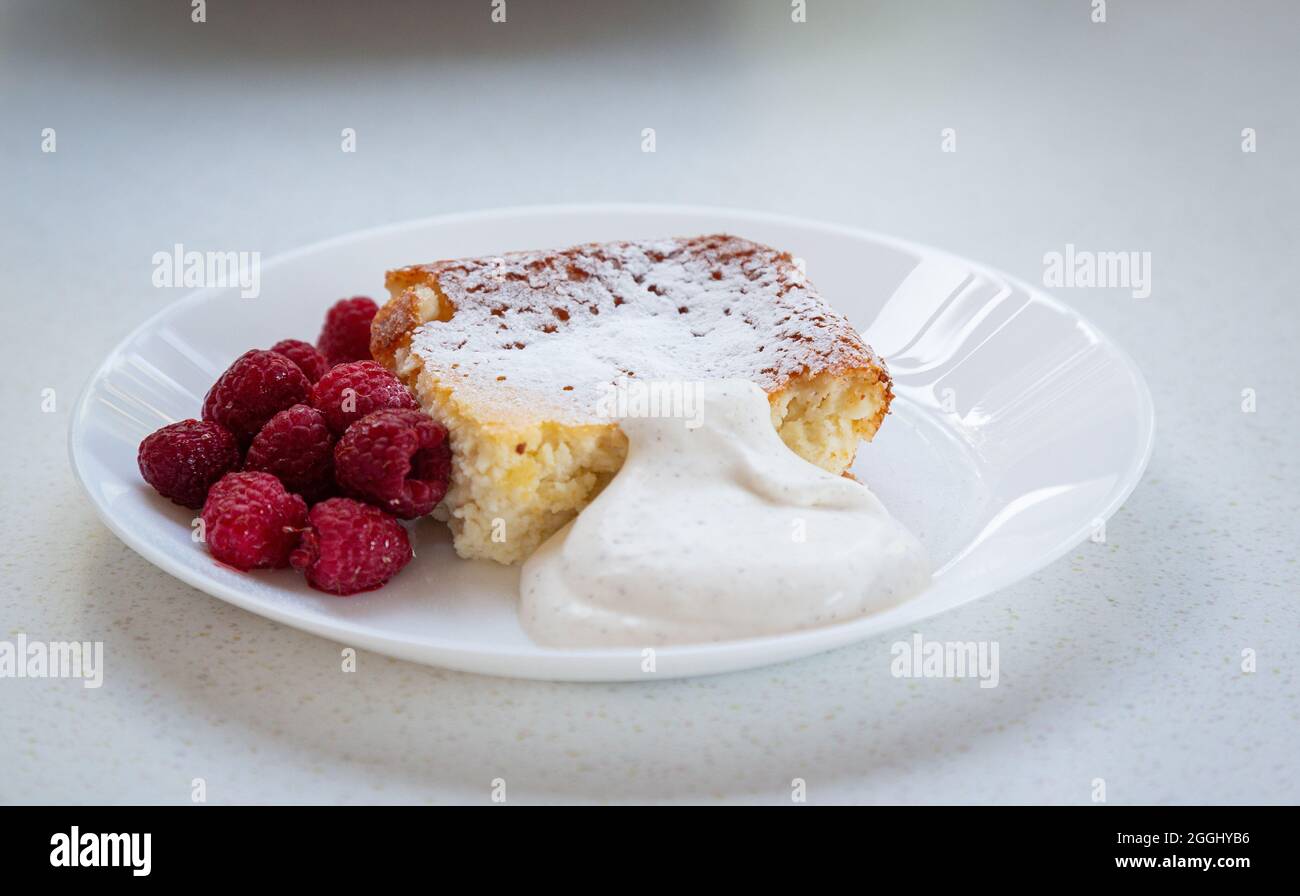 Closeup. Swedish cheese cake with fresh raspberry and whipped cream on ...