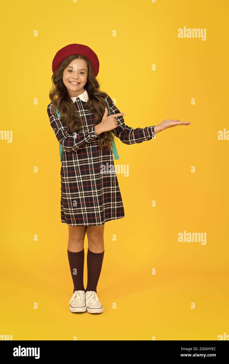 happy kid in school uniform pointing finger, advertisement Stock Photo ...