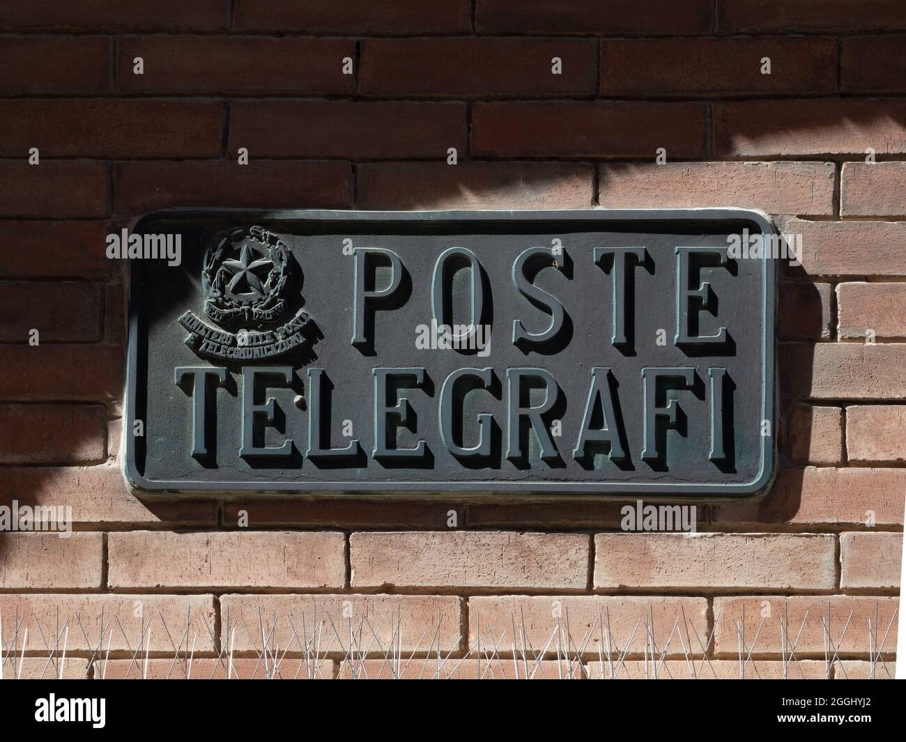 Closeup of an old telegraph posts sign on a brick wall Stock Photo - Alamy