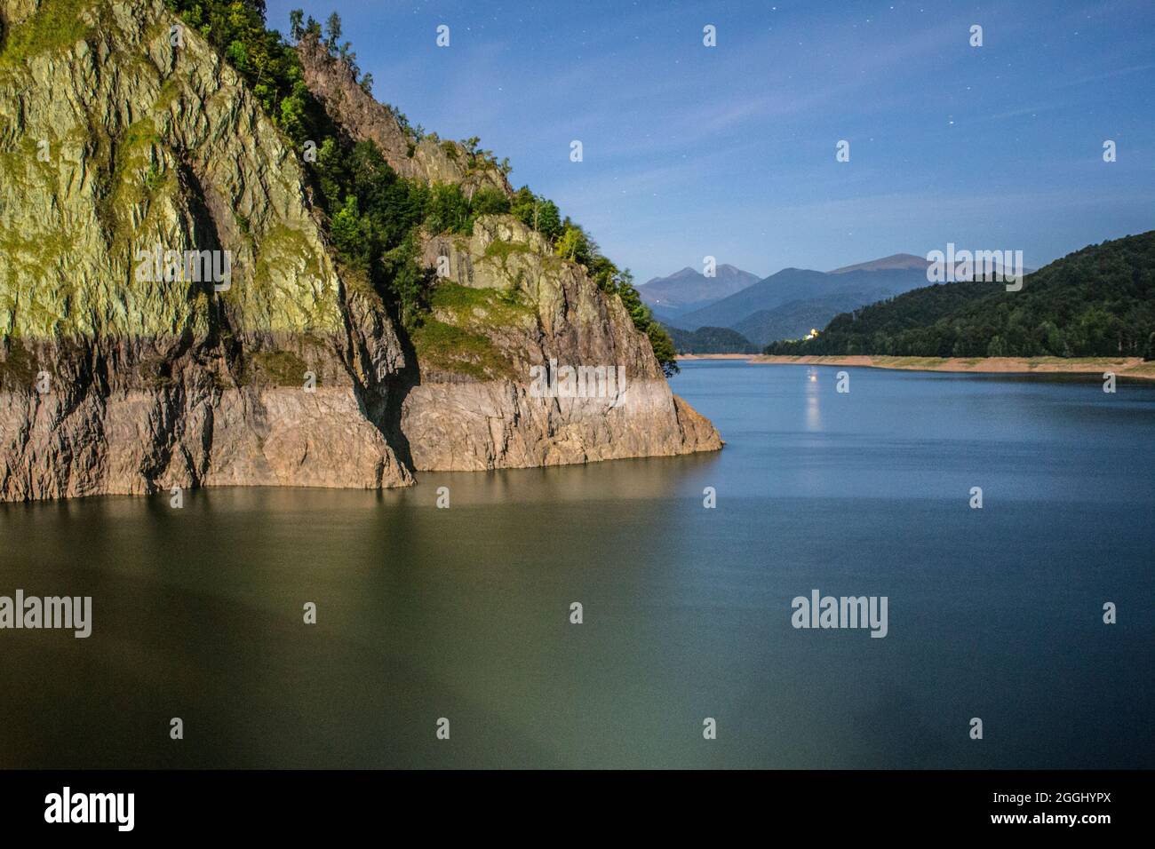 Vidraru Lake with high-level marks on the rocky hill. Arges County ...