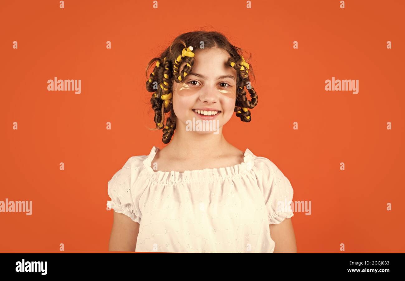 Teen hobbies. Hairstyling. Beautiful girl Curling Hair Using Curlers ...