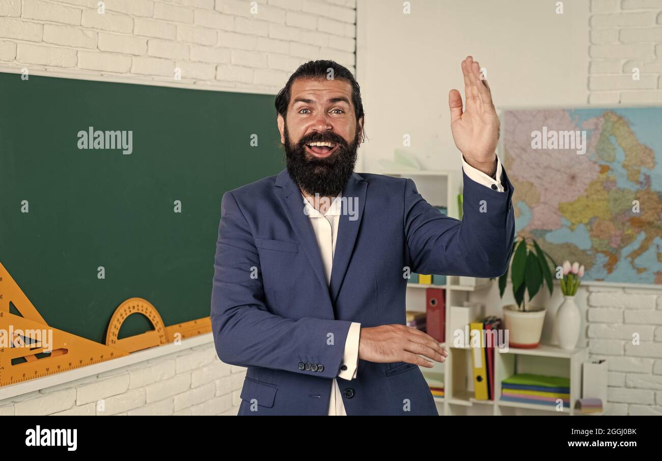 hello. happy man with beard wearing formal suit. process of studying ...