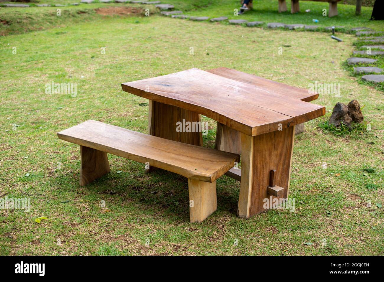 wooden chair in a park with green grass background Stock Photo - Alamy