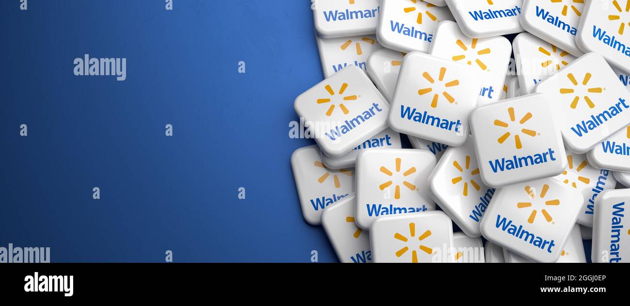 Logos of the retail chain Walmart on a heap on a table. Copy space. Web ...