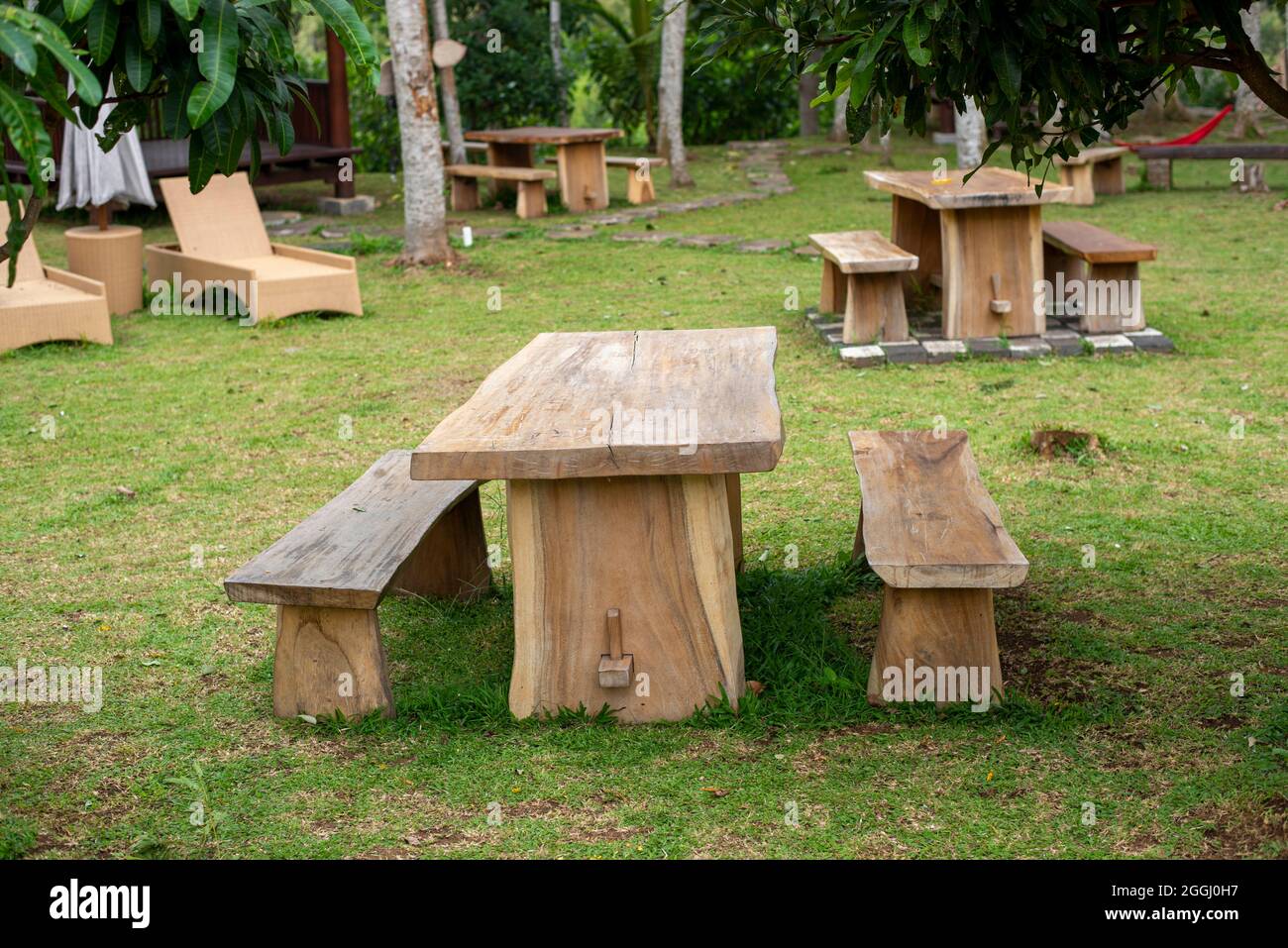 wooden chair in a park with green grass background Stock Photo - Alamy