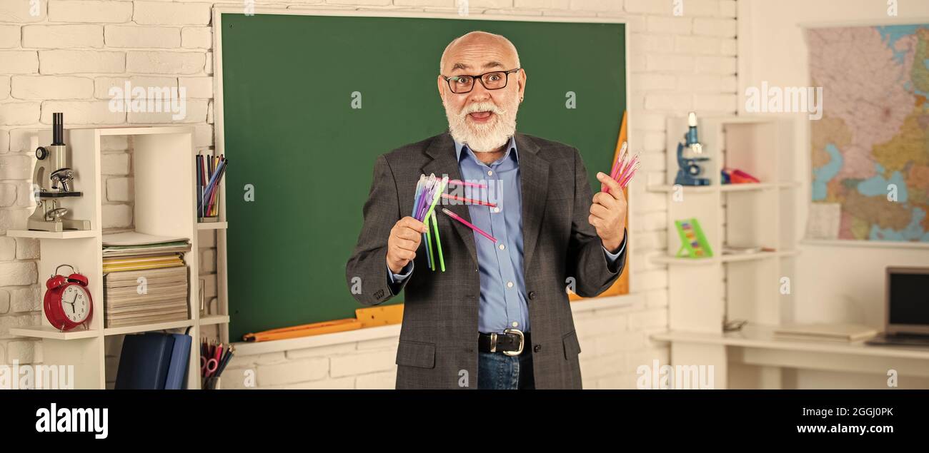 man use many office tools. senior teacher hold colorful pen set. choose ...