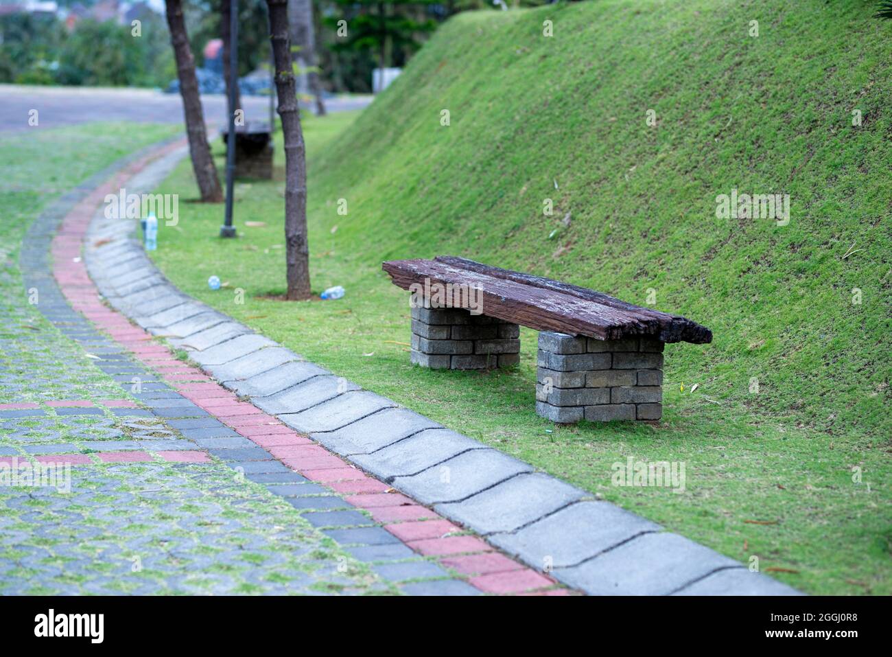 wooden chair in a park with green grass background Stock Photo - Alamy