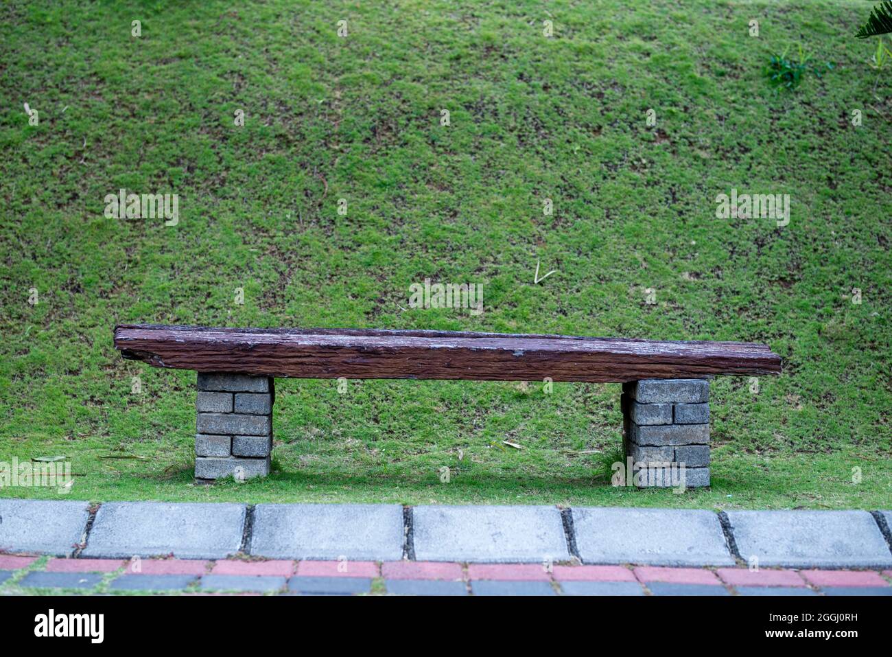 wooden chair in a park with green grass background Stock Photo - Alamy