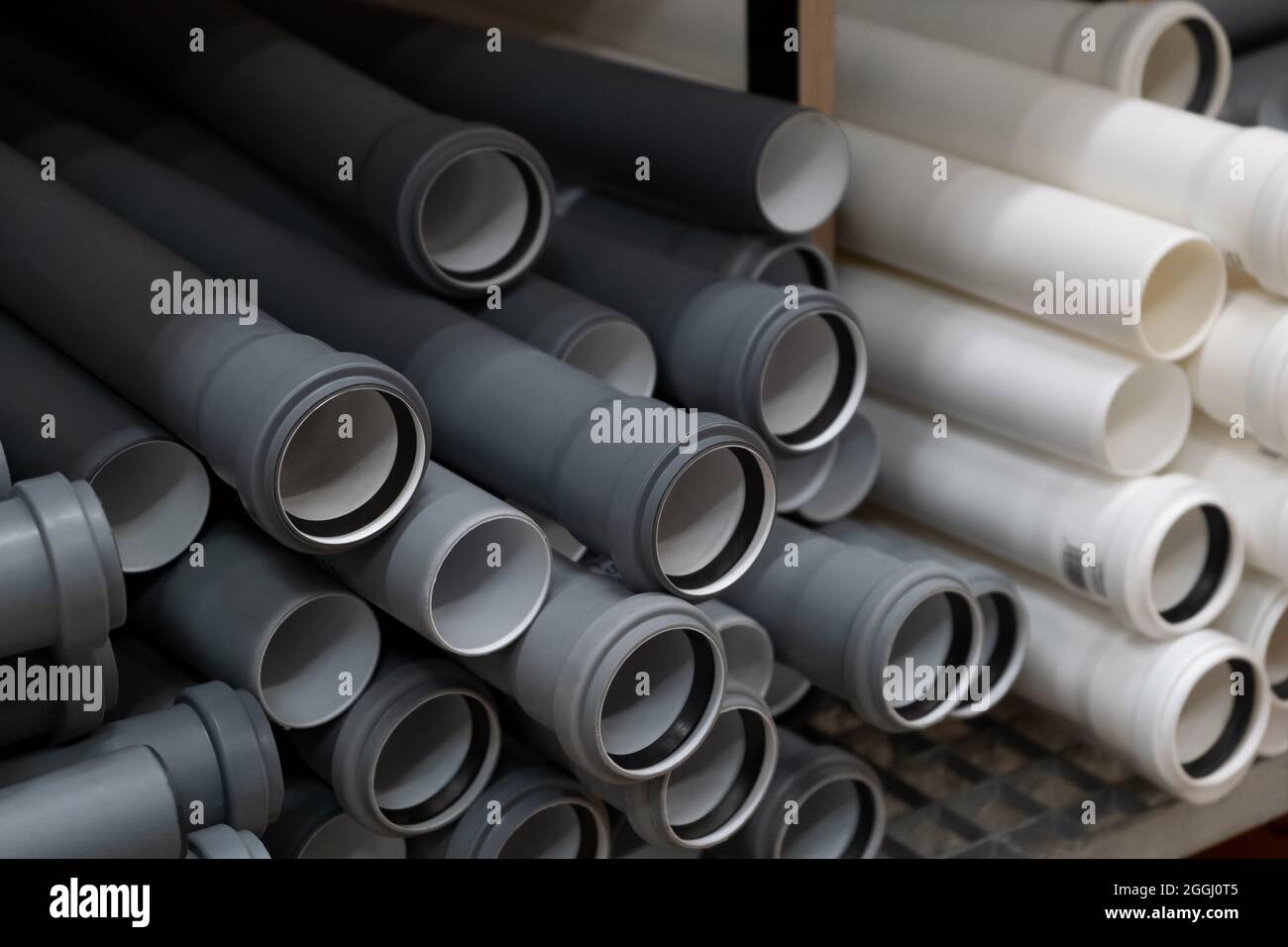 Stack of PVC canalization pipes plumbing tube on a hardware store stock ...