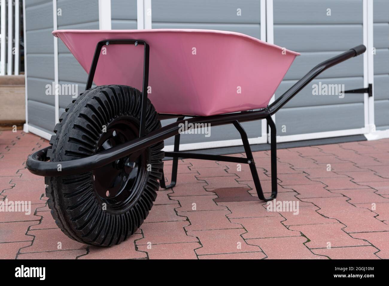 New Pink Garden wheelbarrow cart on backyard on farm, gardening tools ...