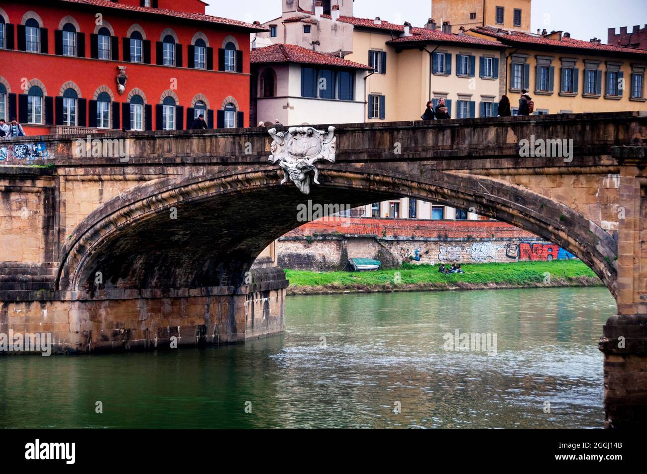 Elliptical stone arch and marble frieze of Ponte Santa Trinita bridge over the Arno in Florence ...