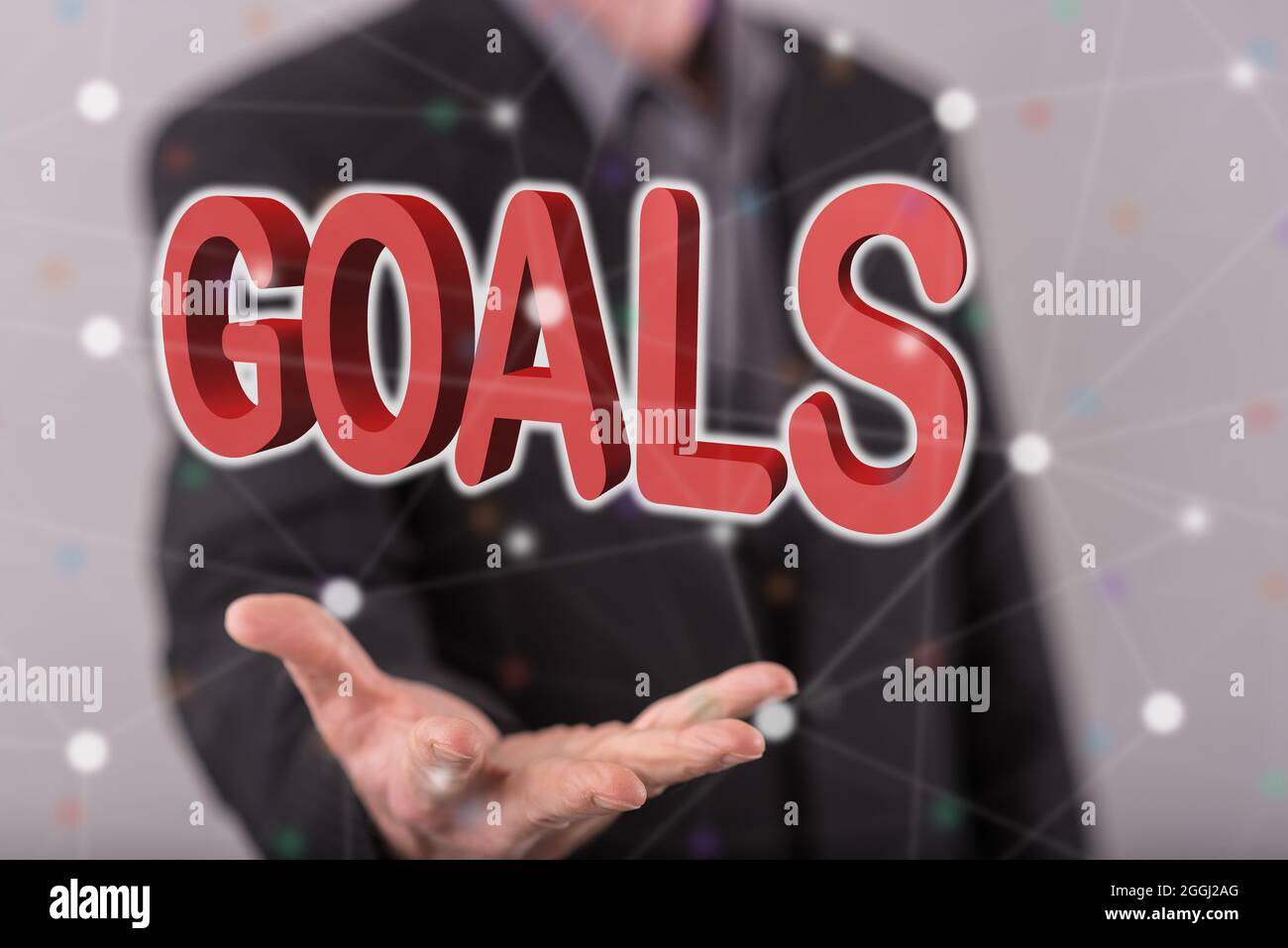 Goals concept above the hand of a man in background Stock Photo - Alamy