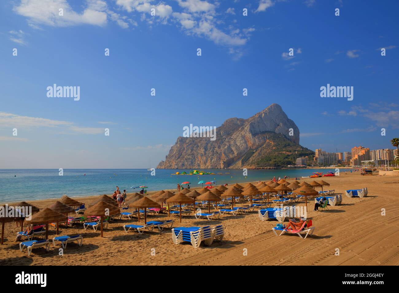 Levante La Fossa beach Calp Spain with rock and beach parasols Stock ...