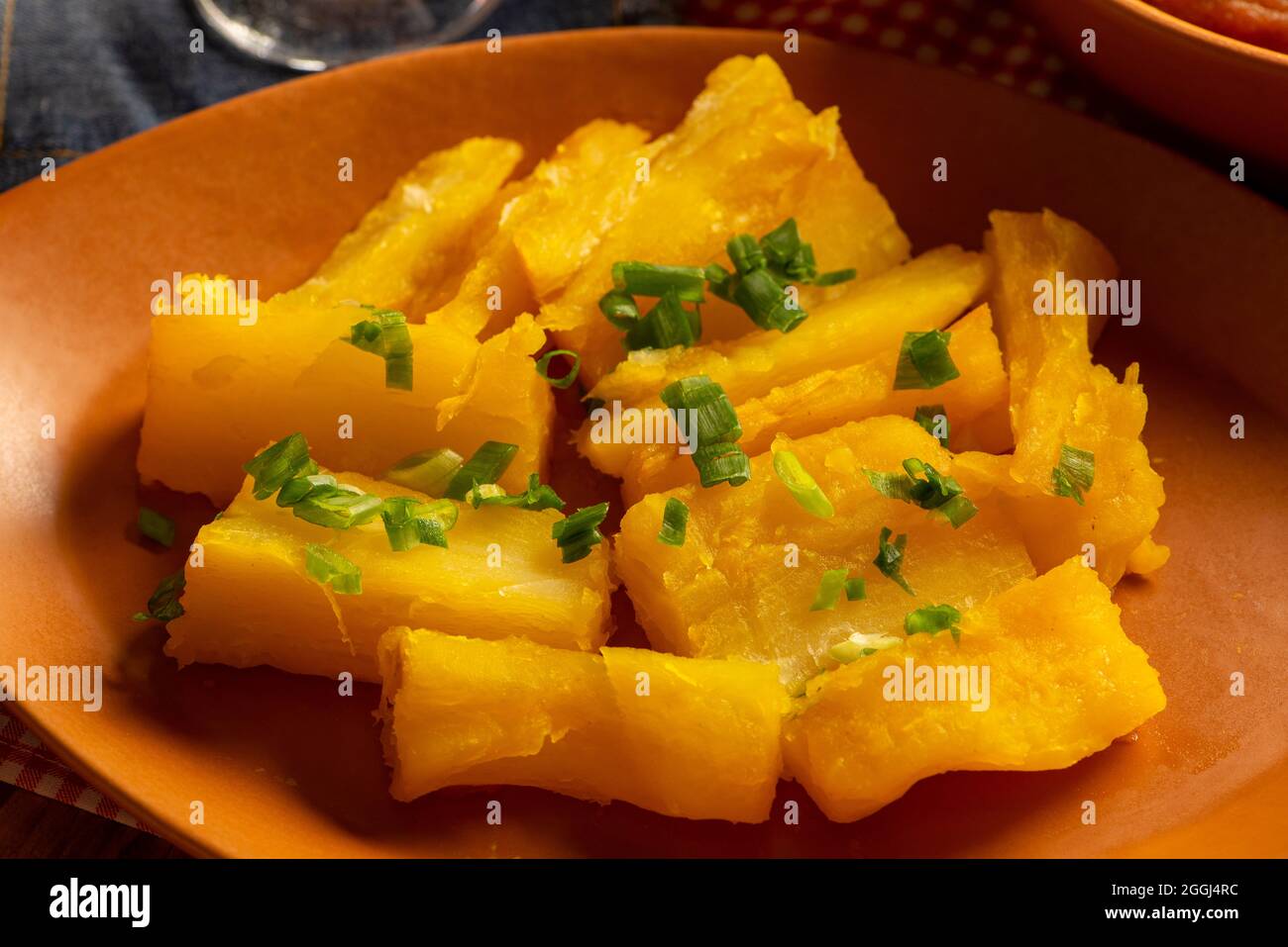 portion of cooked cassava sprinkled with chives Stock Photo - Alamy
