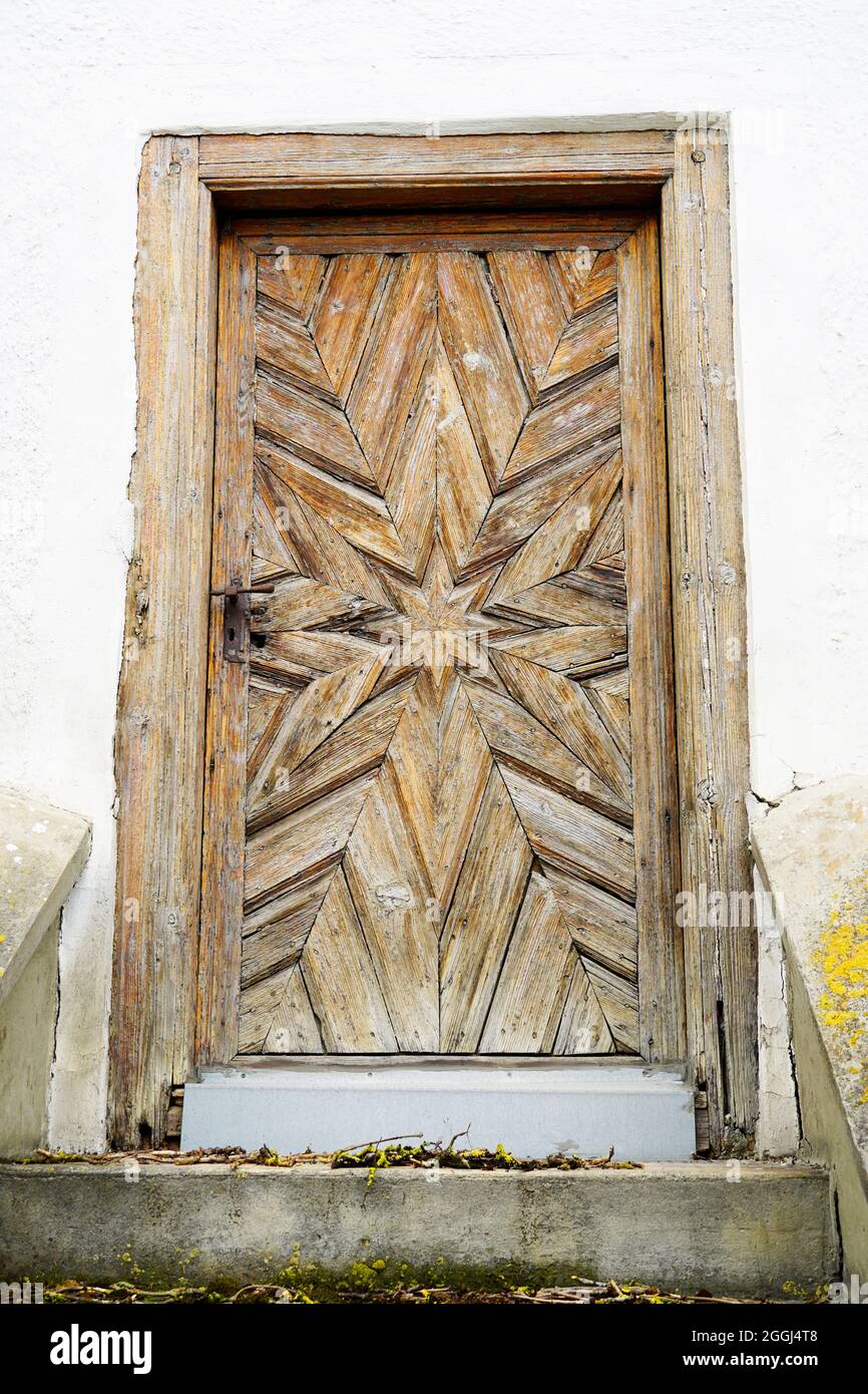 Old weathered wooden door with star-shaped wood carvings Stock Photo ...