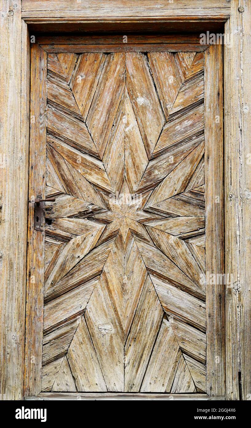 Old weathered wooden door with star-shaped wood carvings Stock Photo ...