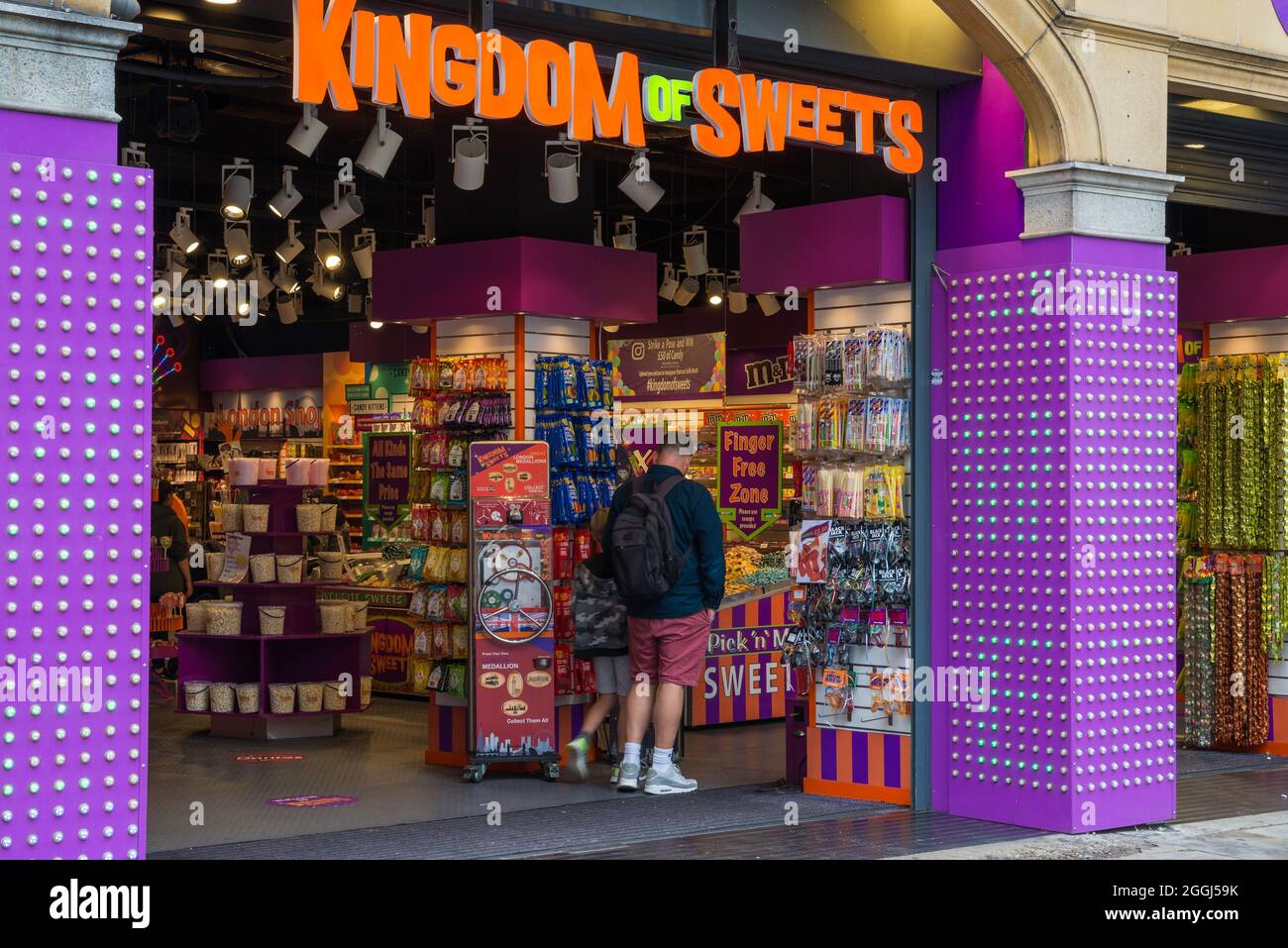 Man and child browse in the Kingdom of Sweets candy store, Piccadilly ...