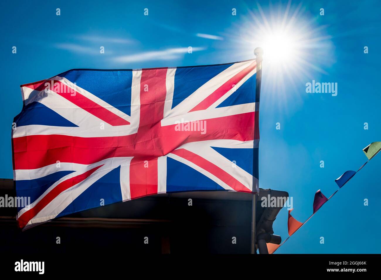 Brilliant sunshine behind Great Britain flag and bunting Stock Photo ...